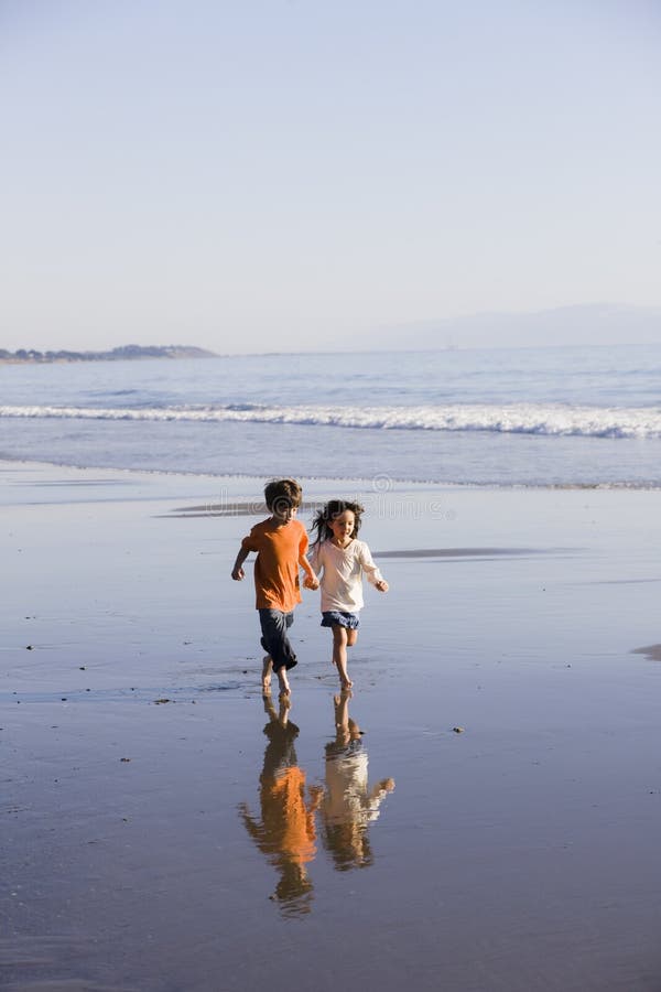 Children Running on Beach stock image. Image of brother - 11847453