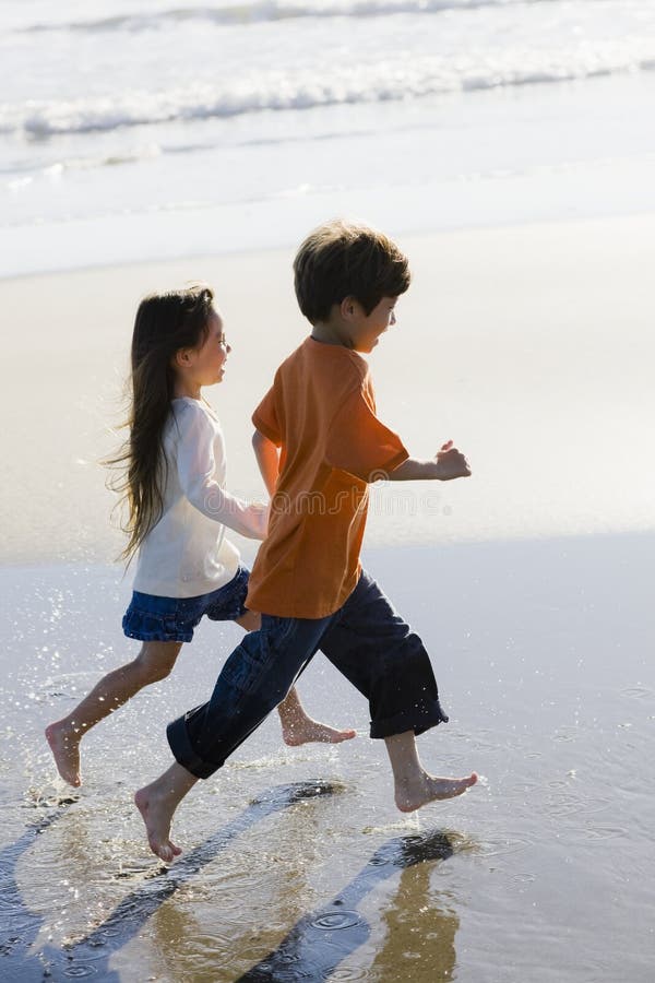 Boy Running on Beach Walkway Stock Photo - Image of tween, horizontal ...