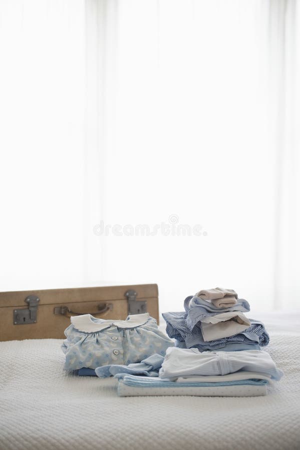 Children S Clothes Folded on Bed Stock Image - Image of room, fashioned ...
