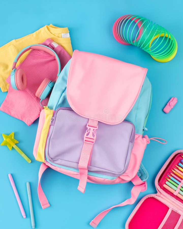 A Children S Colored Backpack on a Blue Background, Surrounded by Toys ...