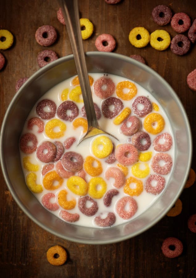 Childrens Dry Multi-colored Flakes with Milk on a Wooden Table Stock ...