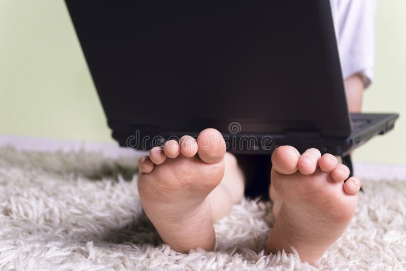 Children& X27;s Feet and Laptop Stock Image - Image of laptop, carpet ...