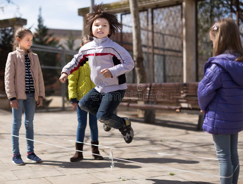 Children S Games. Boy Jumps Over the Rope Stock Image - Image of ...