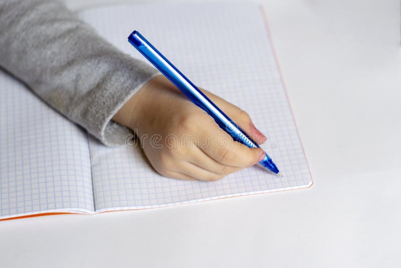 Children`s Hand Writes in a Notebook with a Ballpoint Pen Stock Photo ...