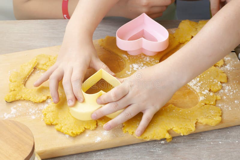 Children`s Hands with a Form for Cookies. Kitchen Utensils in the ...