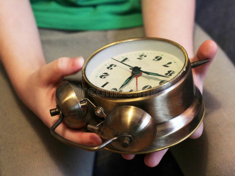 Children`s Hands Holding a Gold Alarm Clock Stock Image - Image of ...
