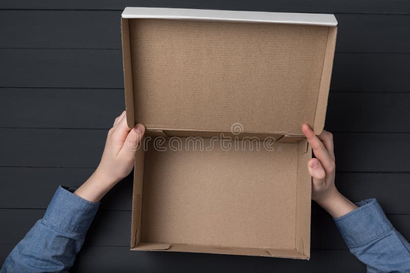 Children`s Hands Holding an Open Cardboard Box. Empty Box, Black ...