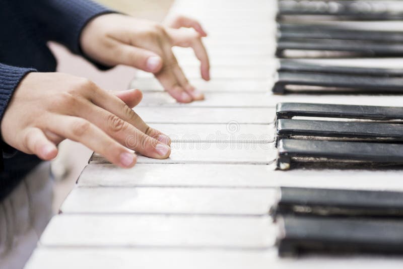 Children`s Hands on the Keys of the Piano. Piano Lessons for Kids Stock ...