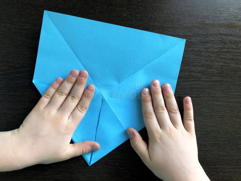 Children S Hands Make Origami from Blue Paper. Children S Creativity ...