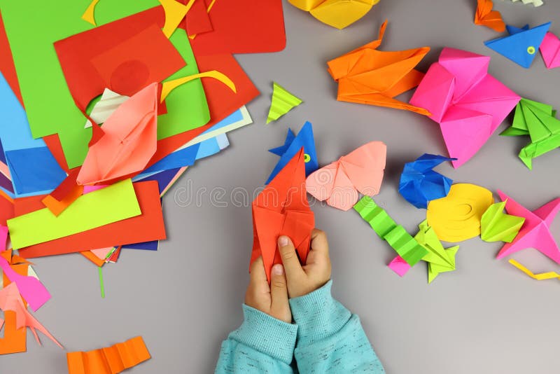 Children& X27;s Hands Make Origami Crafts from Colored Paper Stock ...