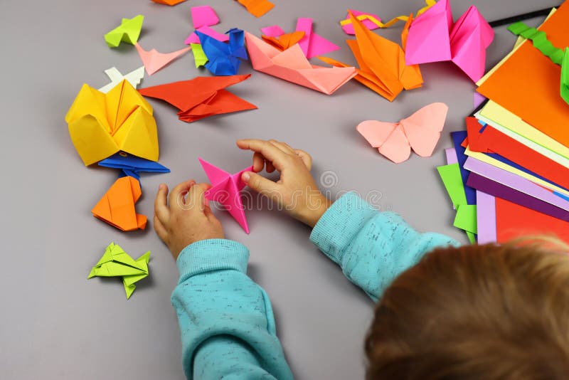 Children S Hands Make Origami Crafts from Colored Paper Stock Image ...