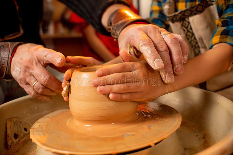 Children`s Hands Work with Clay on a Special Machine. Products from ...