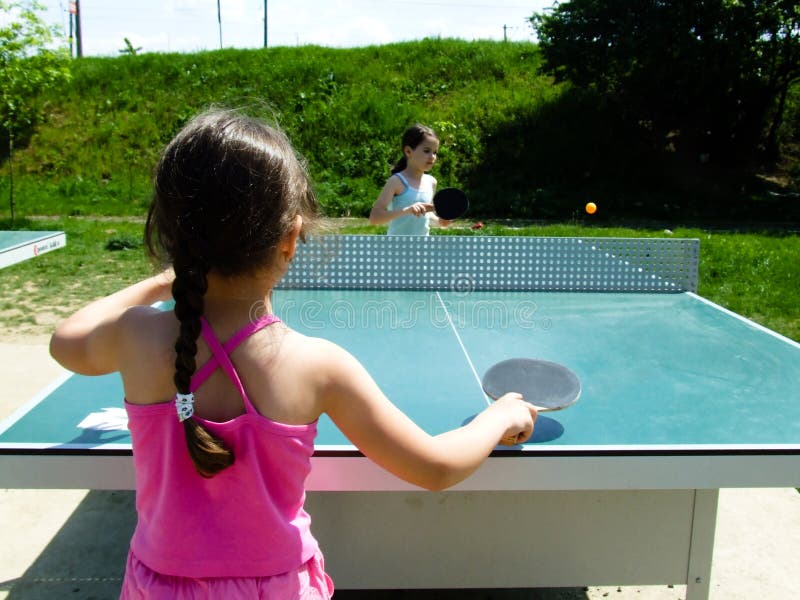 Children's Learn To Play Ping-pong Stock Image - Image of girl, grass ...