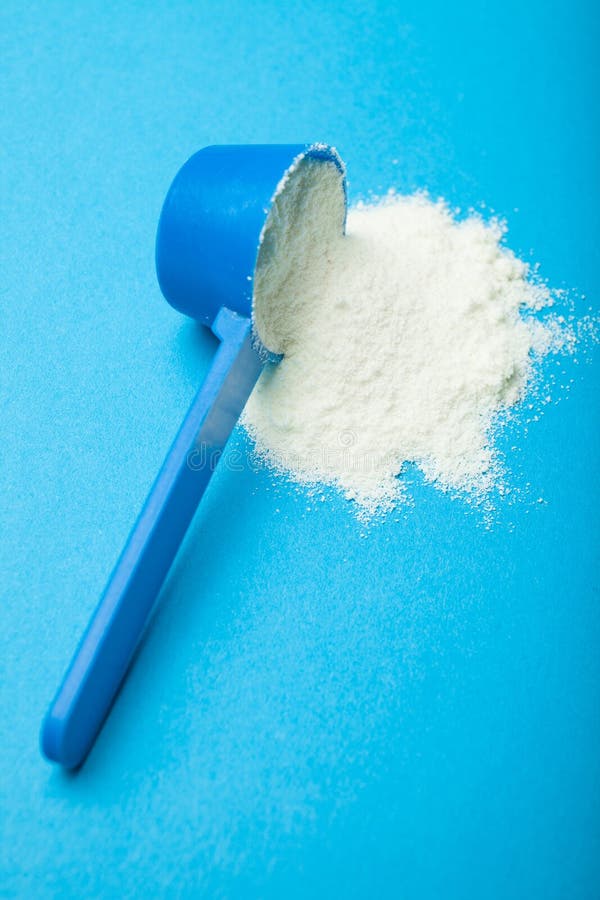Children`s Milk Powder in a Blue Measuring Spoon Stock Photo - Image of ...