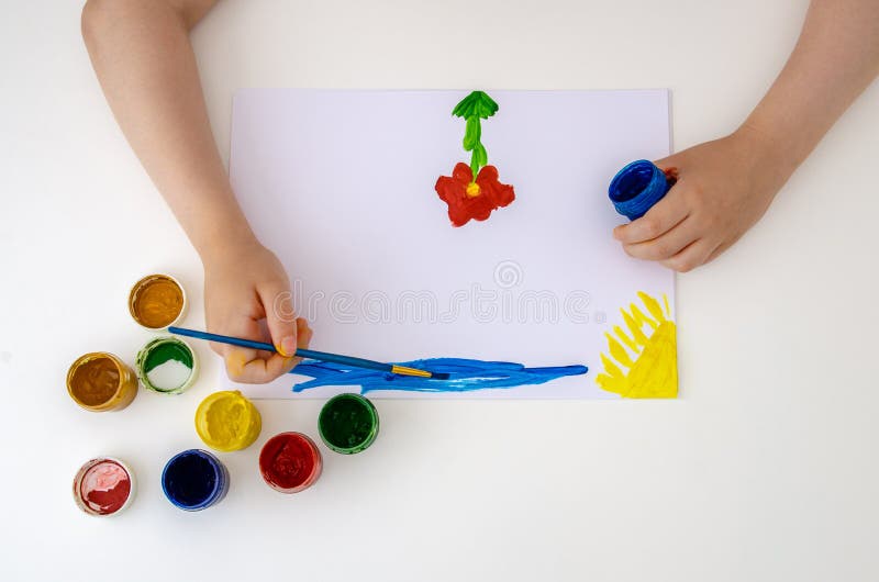 Children S Pens Draw a Drawing of a Flower on a White Background Stock ...