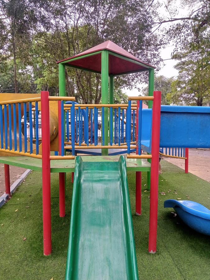 Children& X27;s Playground in the Garden Surrounded by Trees Stock ...