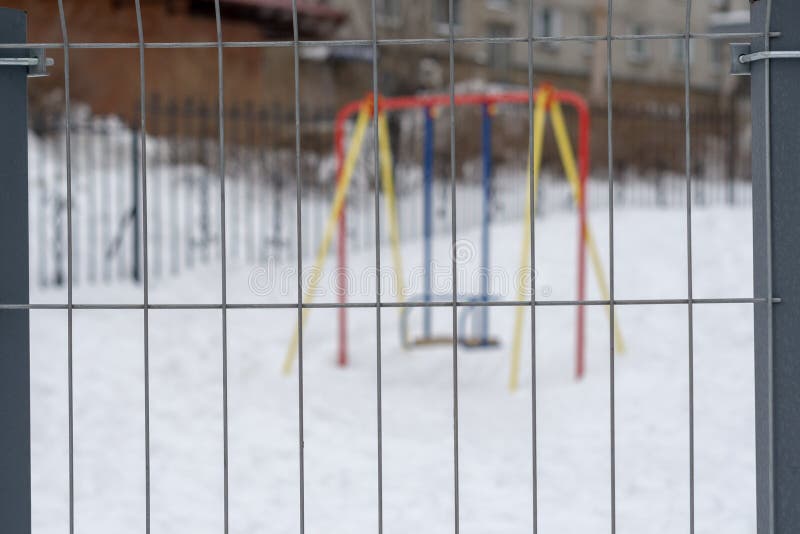 Children`s Swing Behind the Fence. Focus on the Fence Stock Image ...