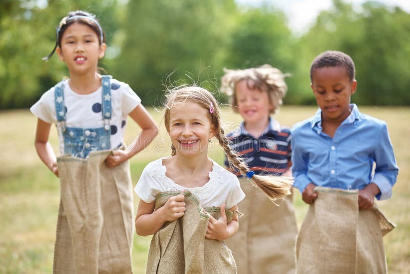 Children at sack race stock photo. Image of interracial - 80634362