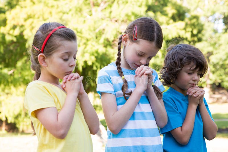 Children Saying Their Prayers In Park Stock Photo - Image: 49900160