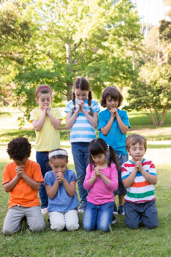 Children Saying Their Prayers in Park Stock Photo - Image of green ...