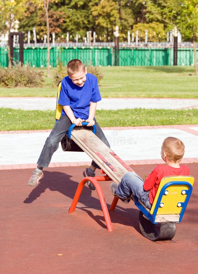 Children on a seesaw stock image. Image of brother, outdoors - 11005683