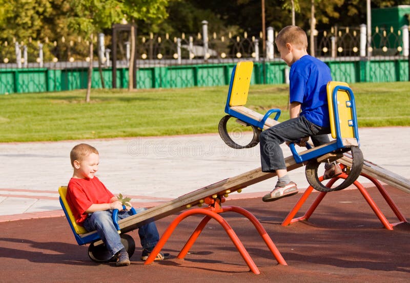 Children on a seesaw stock photo. Image of seesaw, smiling - 11005656