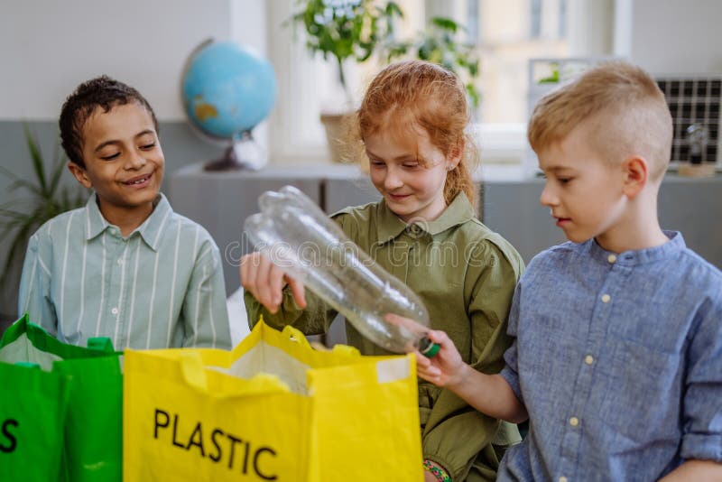 Children Separating Rubish in To Three Bins. Stock Photo - Image of ...