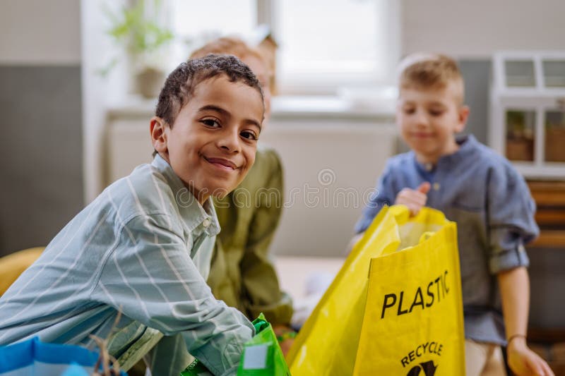 Children Separating Rubish in To Three Bins. Stock Image - Image of ...