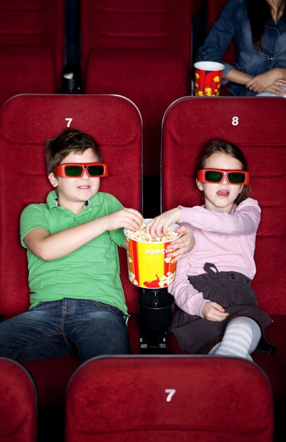 Children sharing popcorn stock image. Image of males - 24812795