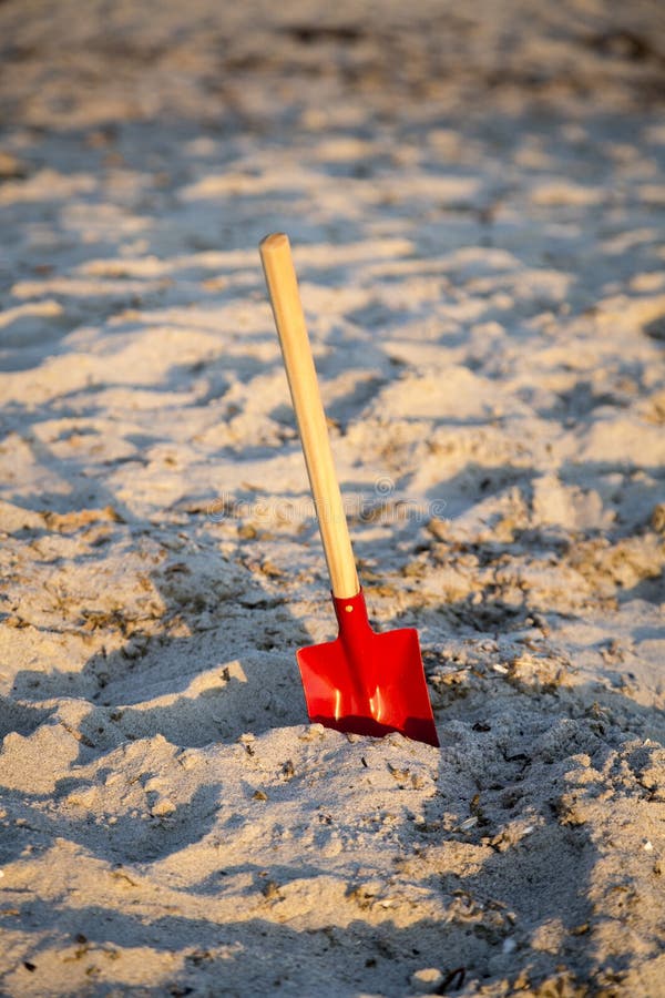 Children Shovel with Sand Figures on a Deserted Beach Stock Photo ...