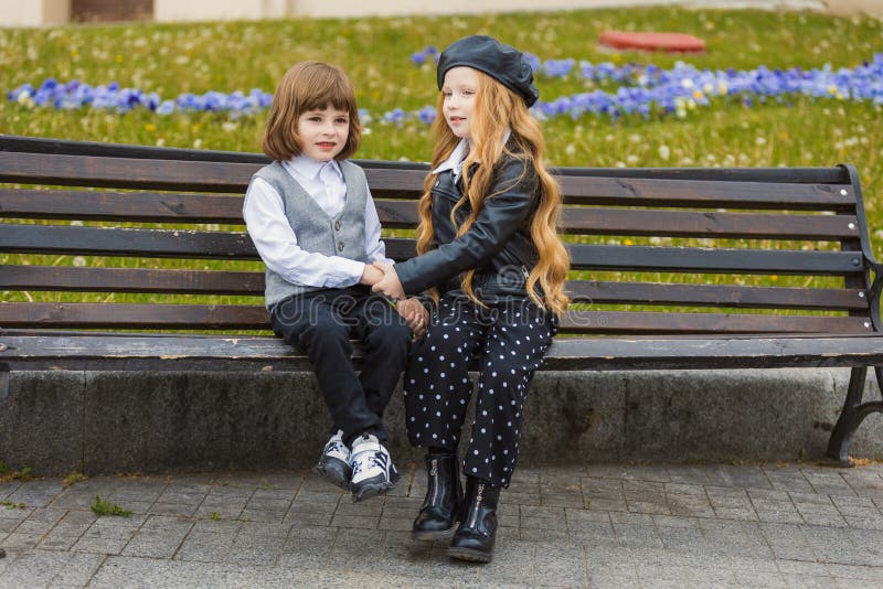Children are Sitting on a Bench Stock Image - Image of childhood ...