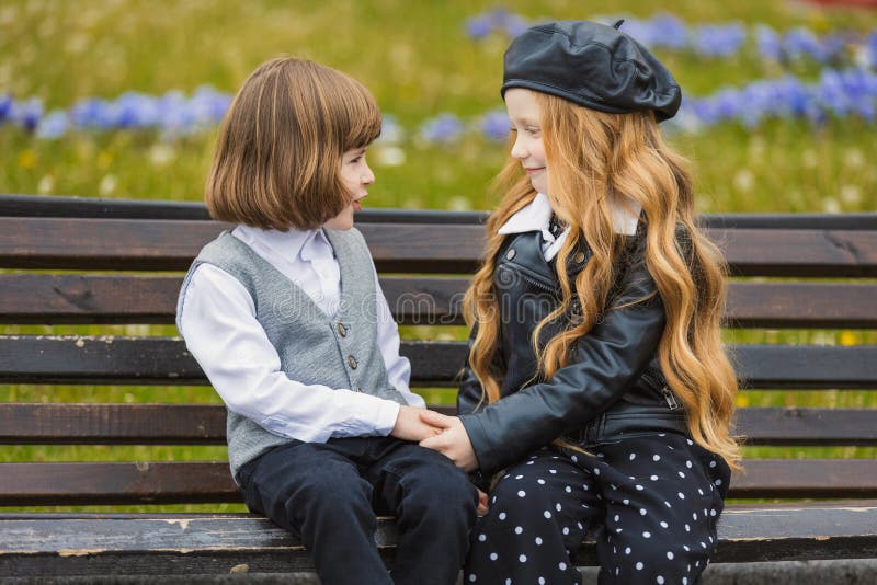 Children are Sitting on a Bench Stock Image - Image of childhood, kids ...