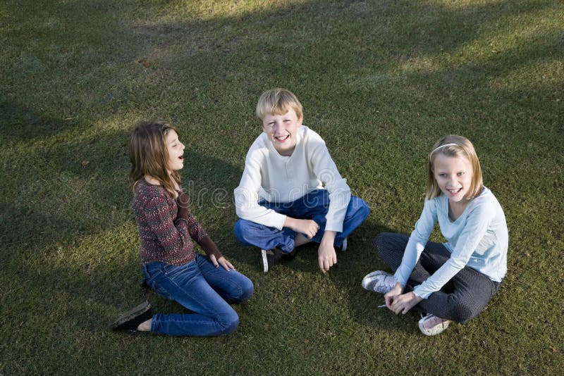 Children Sitting in a Circle on Grass Talking Stock Photo - Image of ...