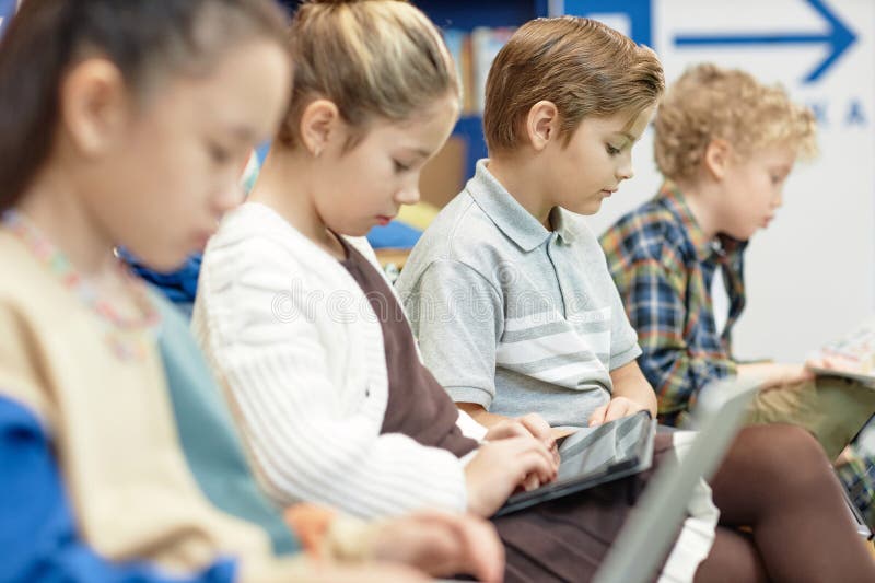 Children Sitting in Row at Library and Using Computers Stock Image ...