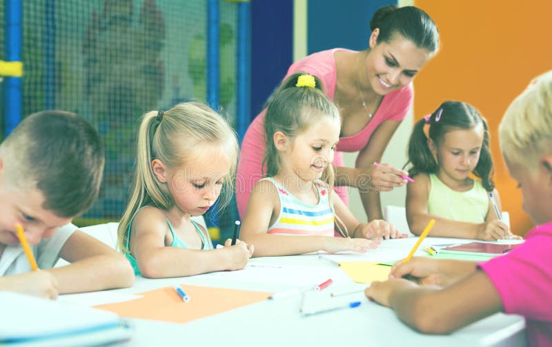 Children Sitting Together and Drawing in Class at School Stock Image ...