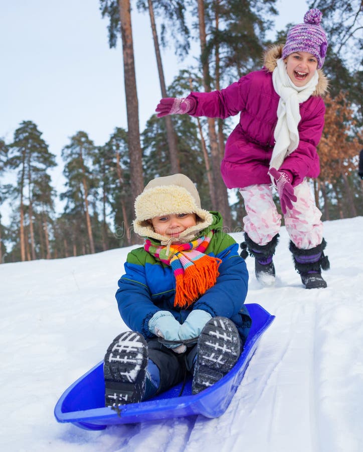 Children on sleds in snow stock image. Image of eyes - 28936603