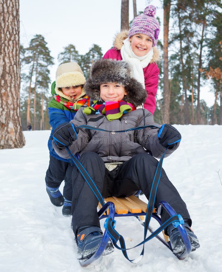 Children on sleds in snow stock image. Image of recreation - 28980193