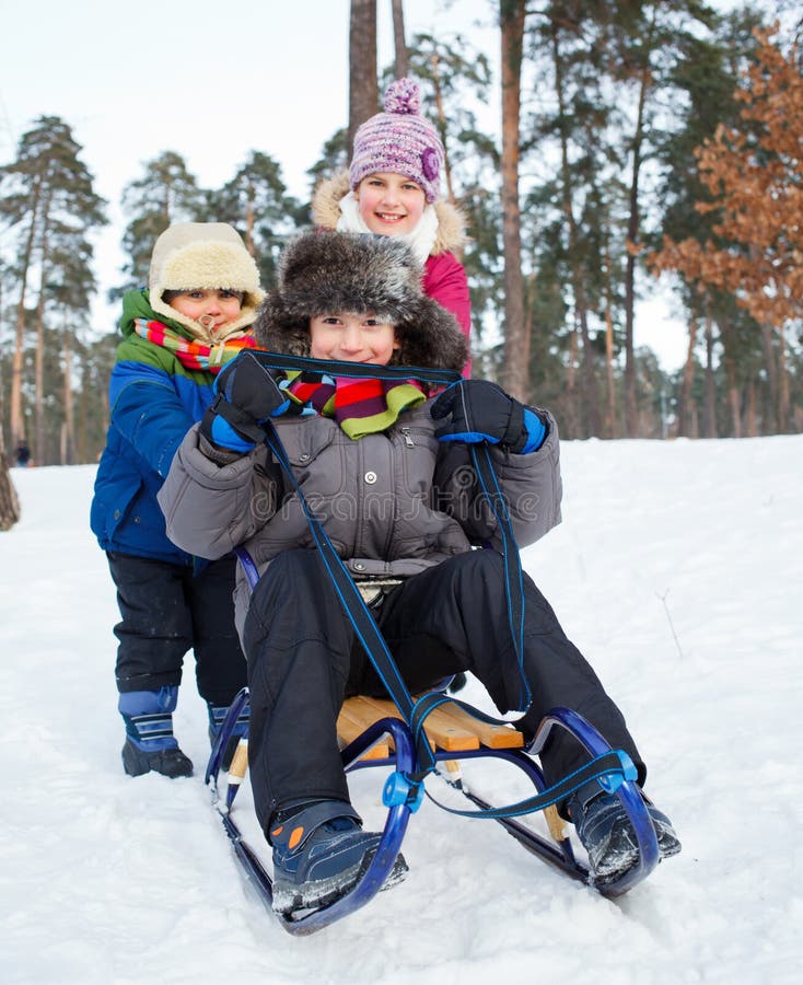 Children on sleds in snow stock photo. Image of girl - 34837292