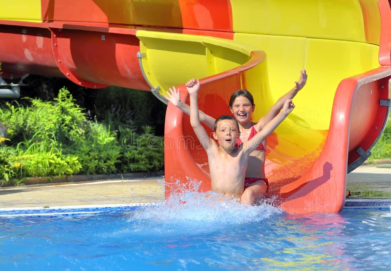 Children Sliding Down a Water Slide Stock Photo - Image of chute ...