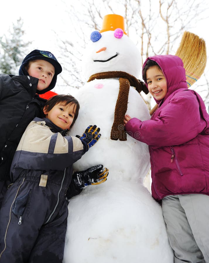 Children on Snow with Snowman Stock Photo - Image of christmas, girl ...