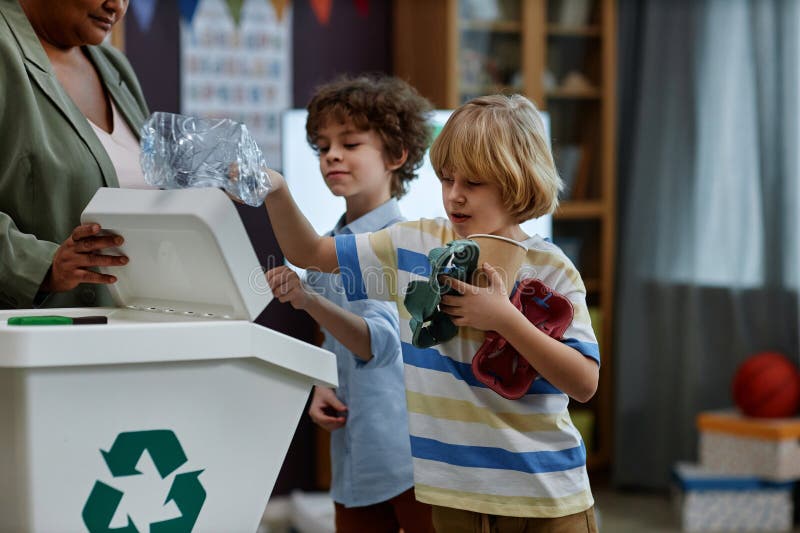 Children Sorting Plastic and Paper in Recycling Class at Preschool ...