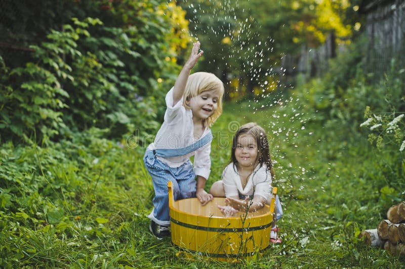 Children Play with Water in the Garden 4752. Stock Image - Image of ...
