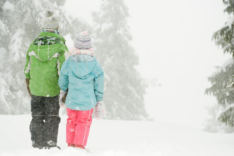 Children Standing in the Snow Stock Image - Image of family, outdoor ...