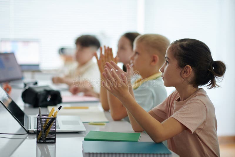 Children Studying in Classroom Seated at Desk Stock Photo - Image of ...