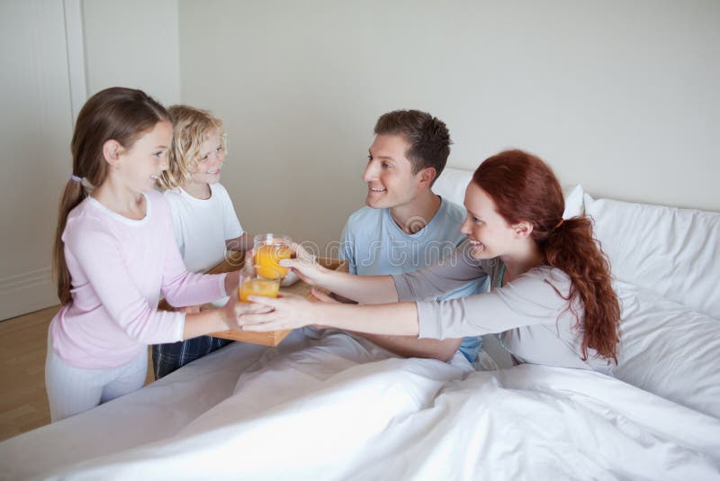 Children Surprising Their Parents with Breakfast Stock Photo - Image of ...