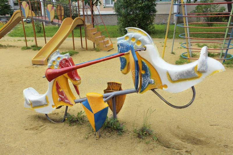 Children Swing in the Form of Horses. Playground. Stock Image - Image ...