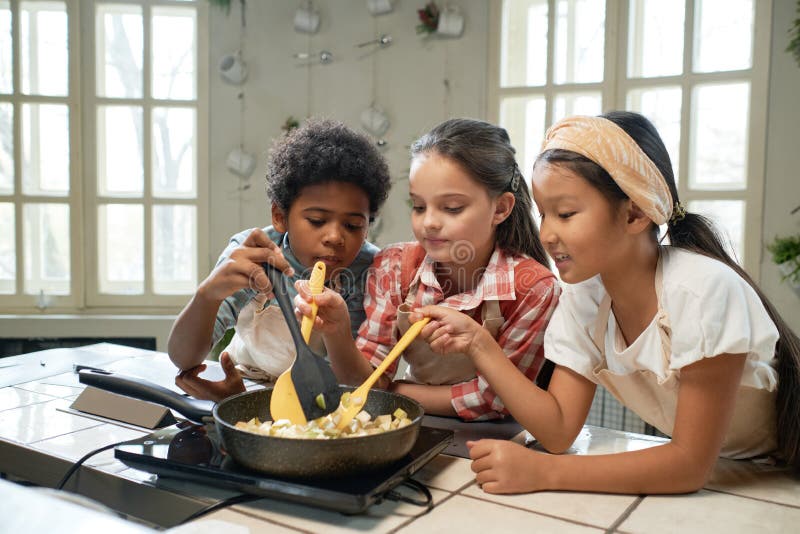 Children Tasting the Food during Cooking Stock Photo - Image of food ...