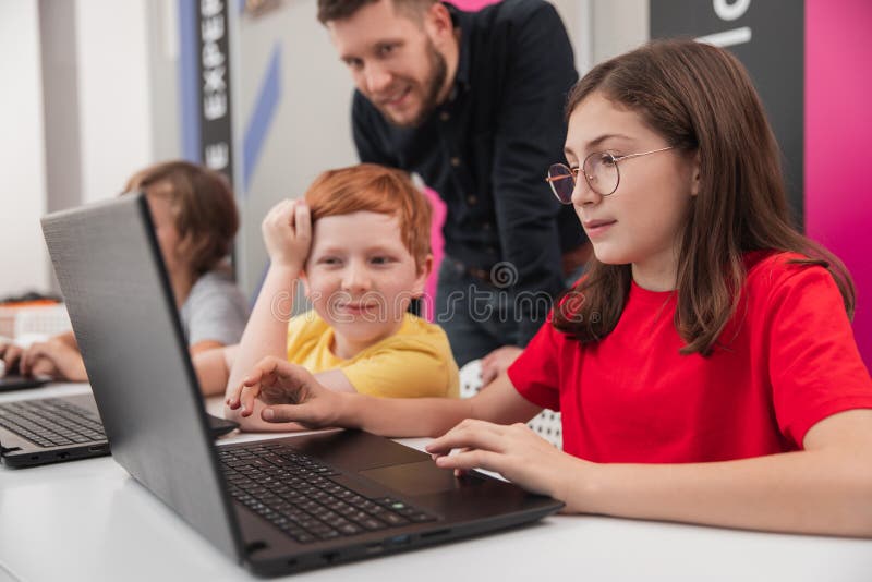 Children with Teacher Working on Laptops Stock Photo - Image of ...