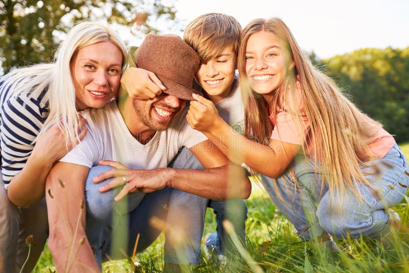 Children Tease and Tease Their Father in the Park Stock Photo - Image ...