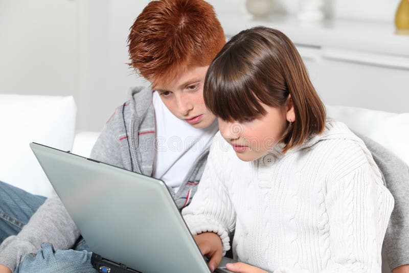 Siblings Using Laptop while Doing Homework Stock Photo - Image of ...